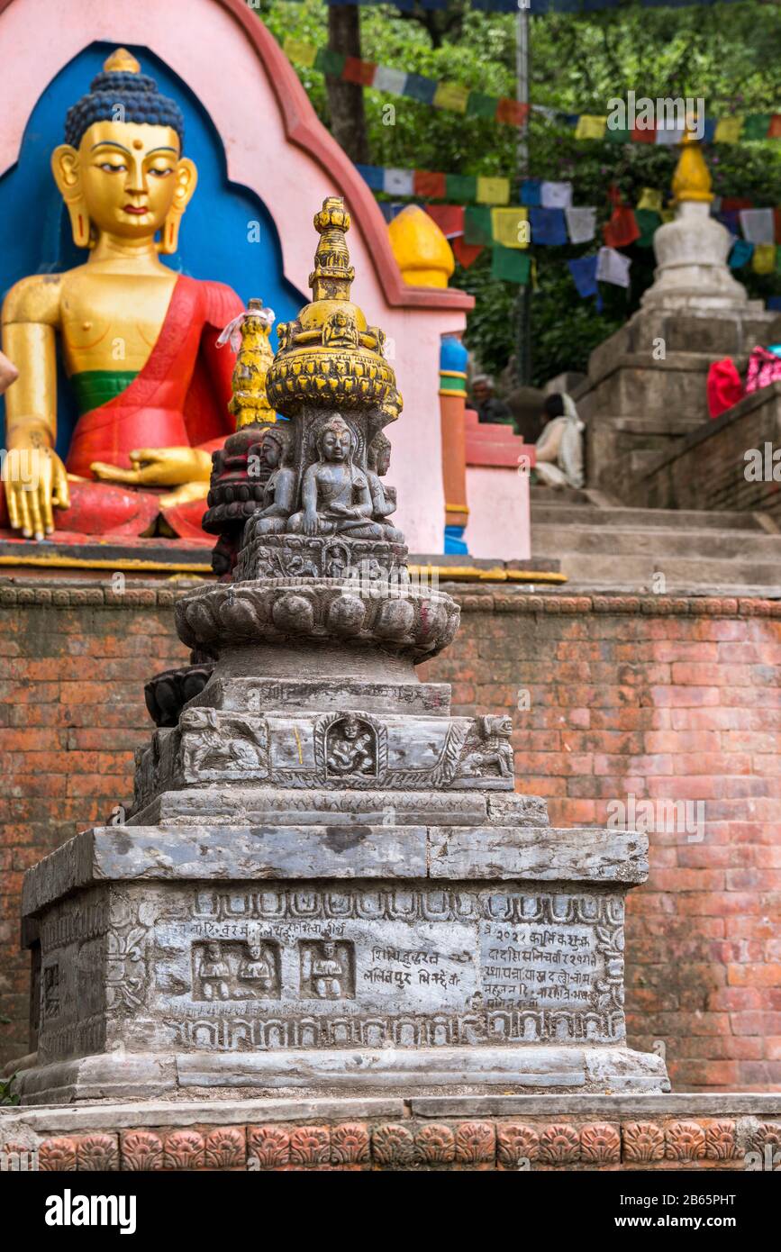 Chaityas and statue of Buddha at the bottom of Eastern stairway leading ...