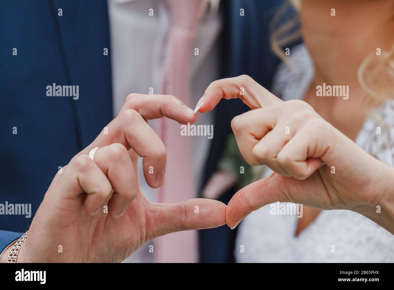 the bride and groom's hands make a heart shape Stock Photo - Alamy