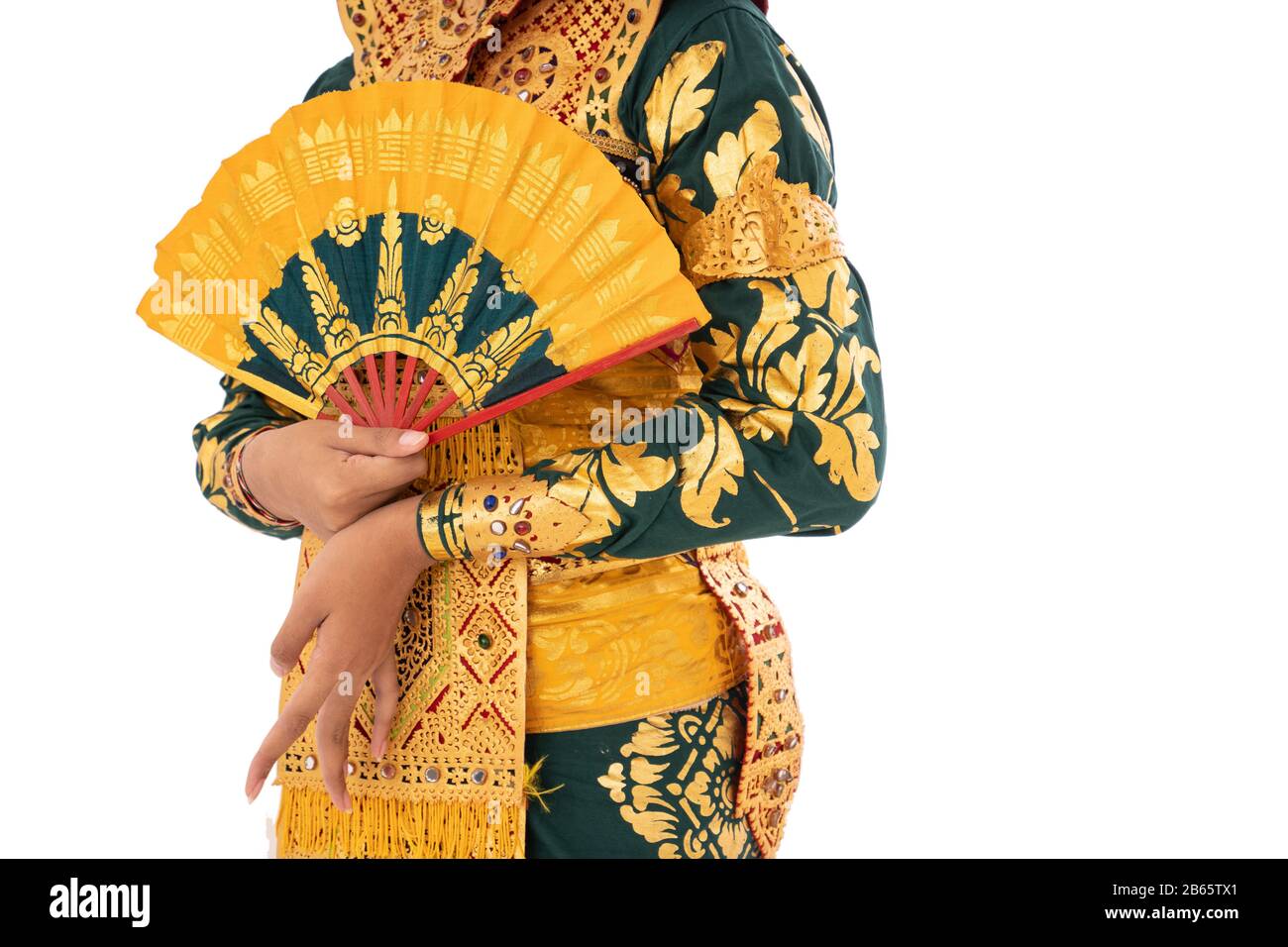 cropped picture of woman Balinese dancers standing hold a fan ...