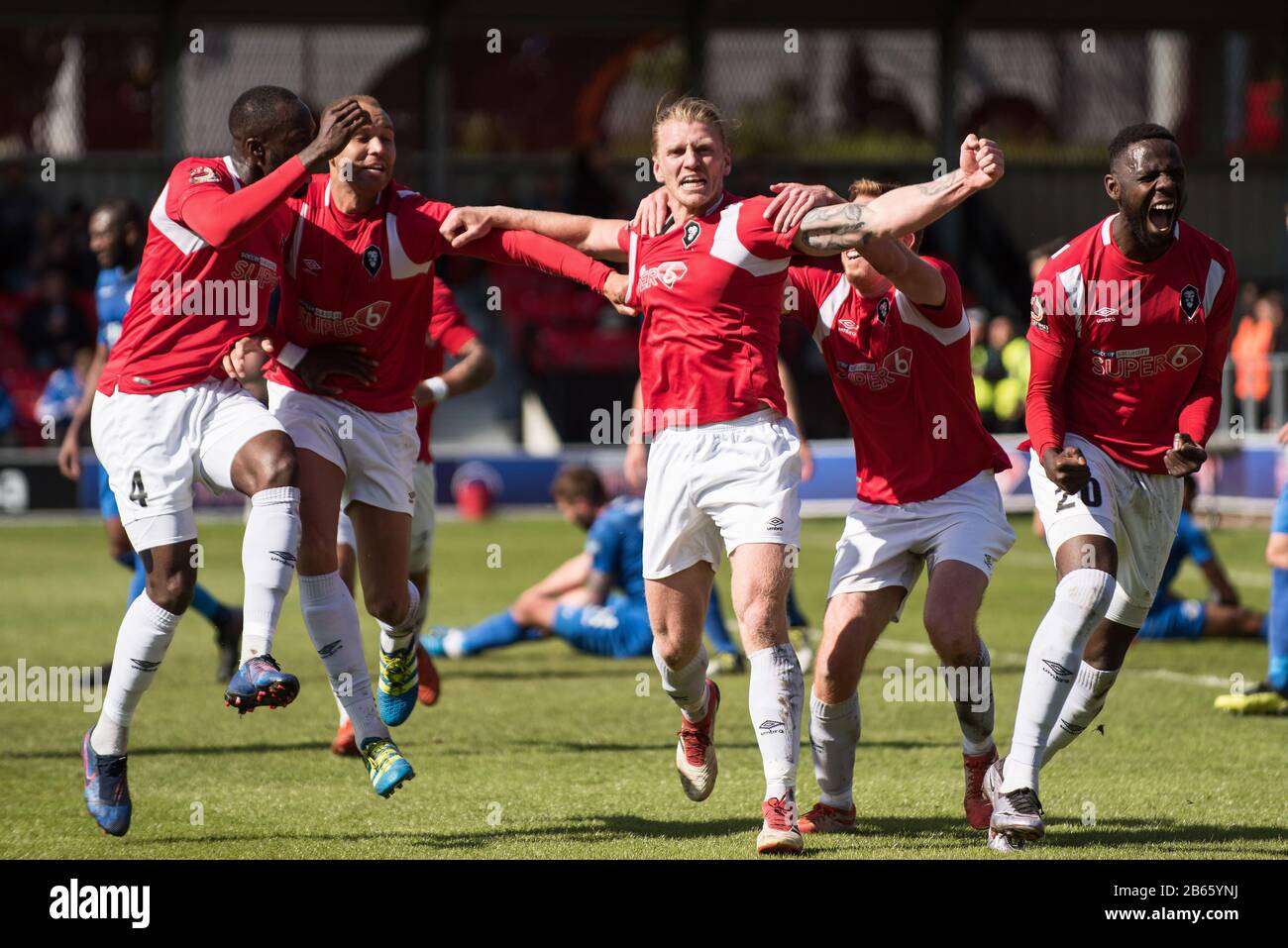 Salford City players celebrate with defender Carl Piergianni after his ...