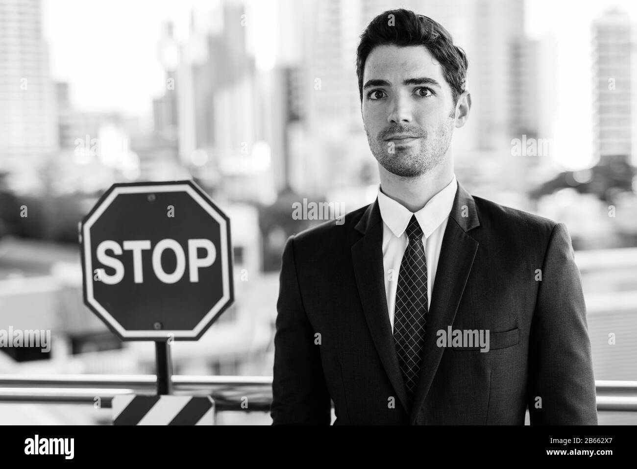 Portrait of young handsome businessman with stop sign Stock Photo - Alamy
