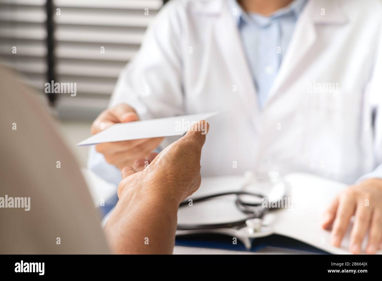 Doctor giving patient documents hi-res stock photography and images - Alamy