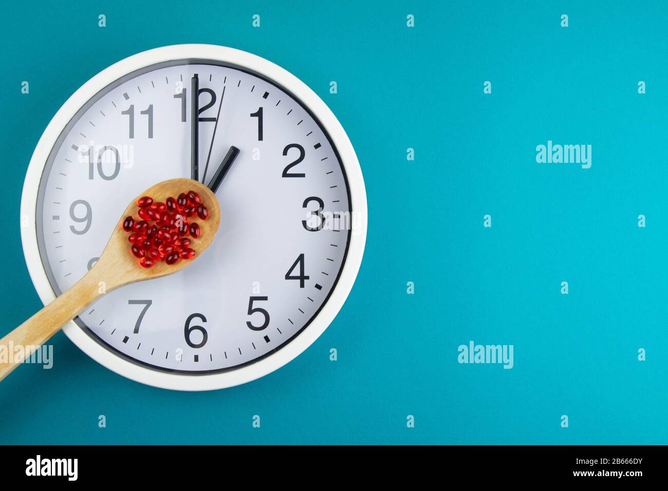 The concept of taking medication. Red pills and a clock that indicate ...