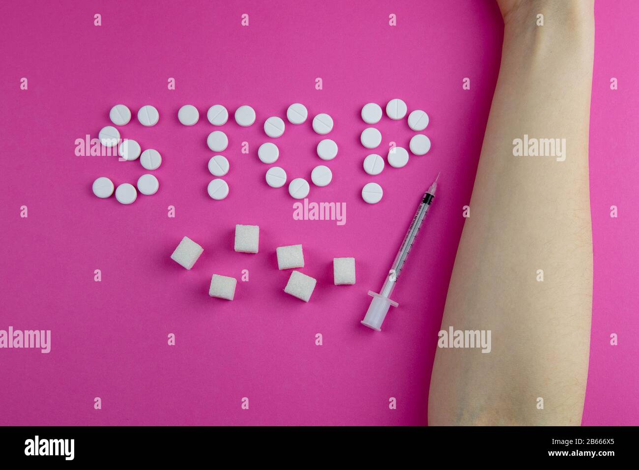 The word stop is made of tablets, next to the outline of the hand ...