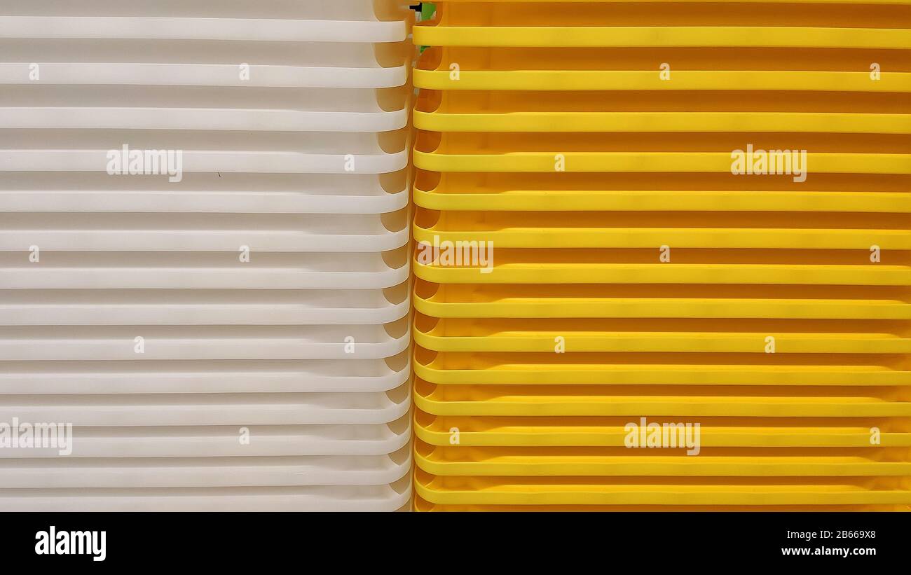 Stack of white and yellow recycled plastic containers in a store ...