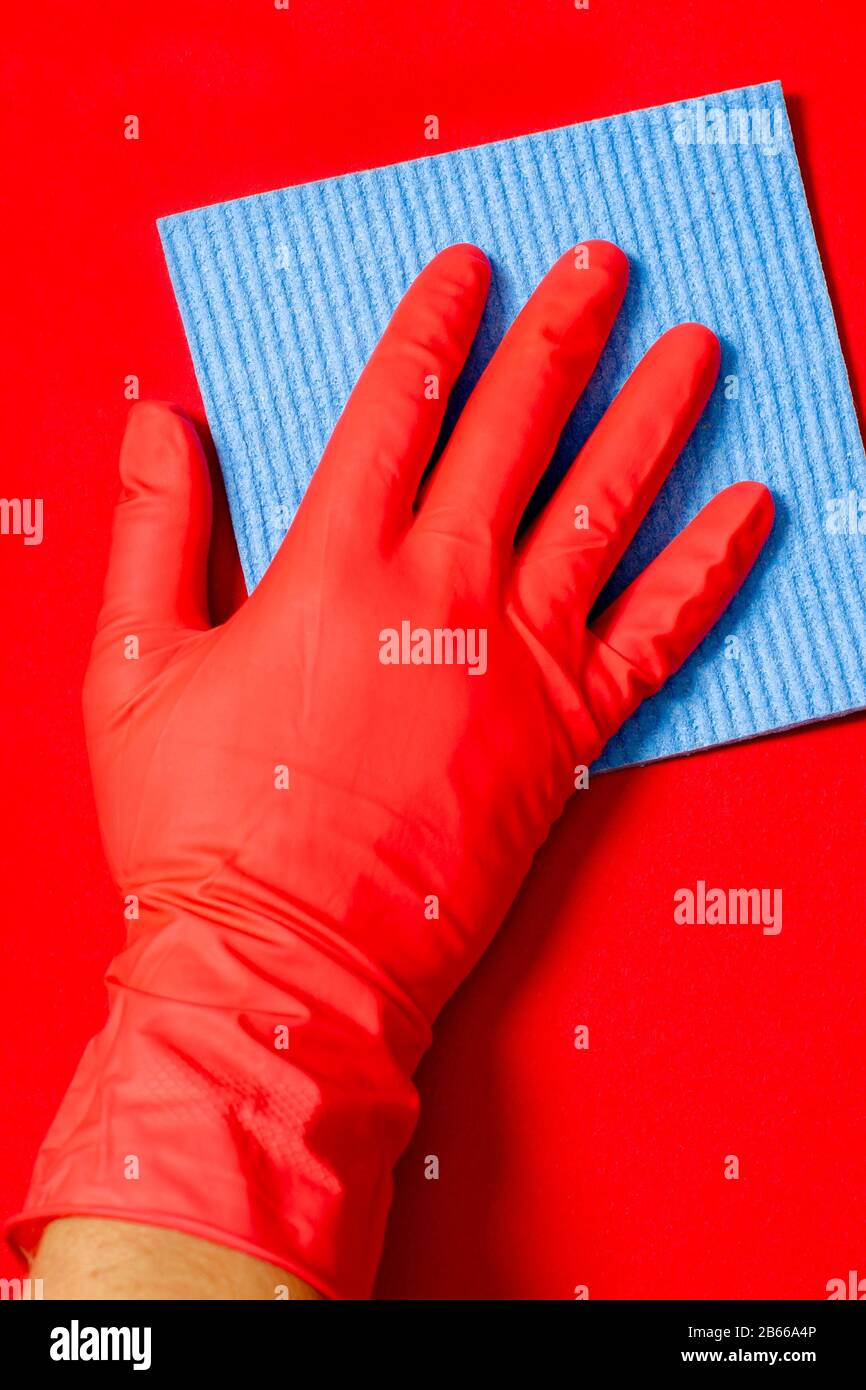 Blue house cleaning sponge in hand in red rubber glove on red ...