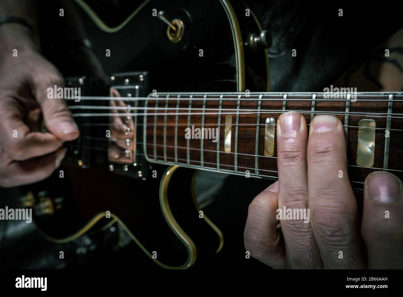 Guitar Player bending black Les Paul like a rockstar Stock Photo - Alamy
