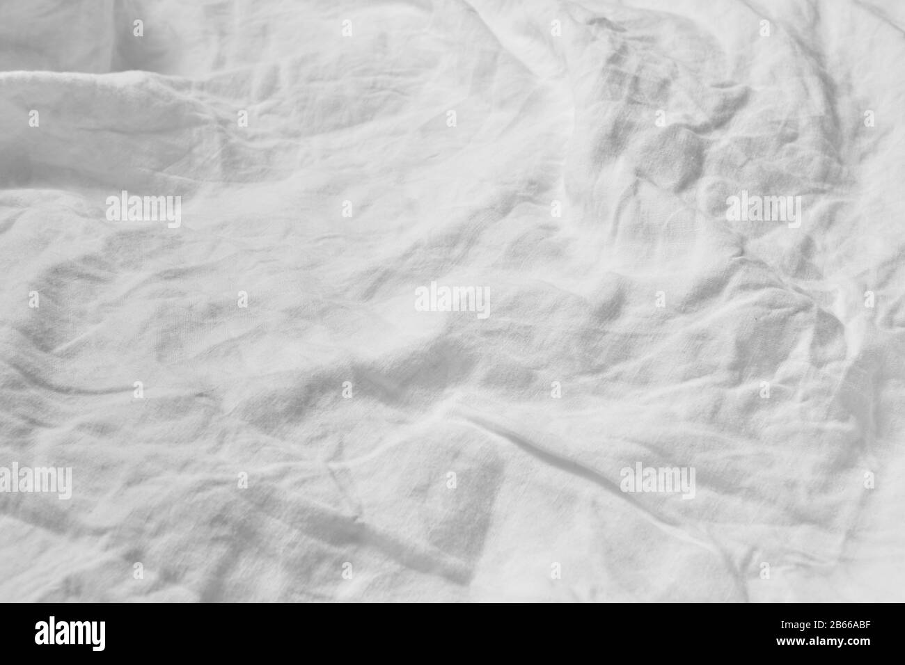Crumpled fabric white textile background Stock Photo - Alamy