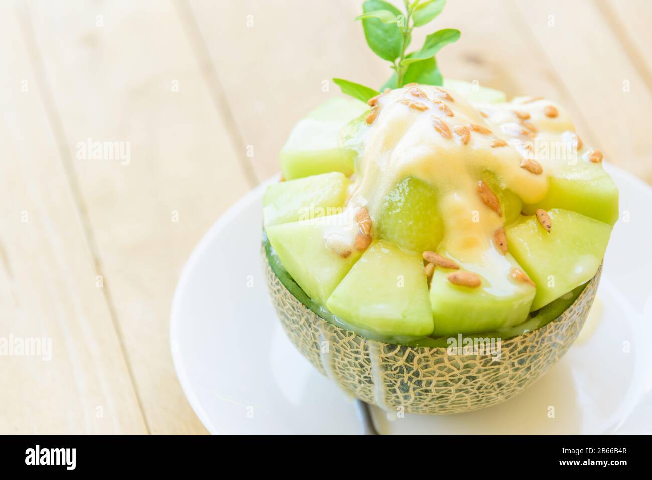 Melon Bingsu with Sweetened Condensed Milk on wood table Stock Photo ...
