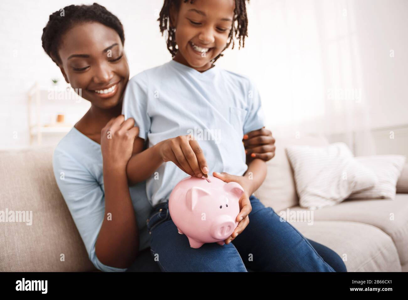 African american family saving money for education Stock Photo - Alamy