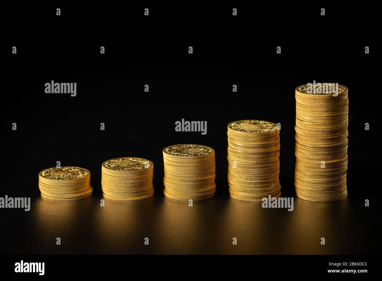 Closeup of stacks of old gold coins in a row, black background Stock ...