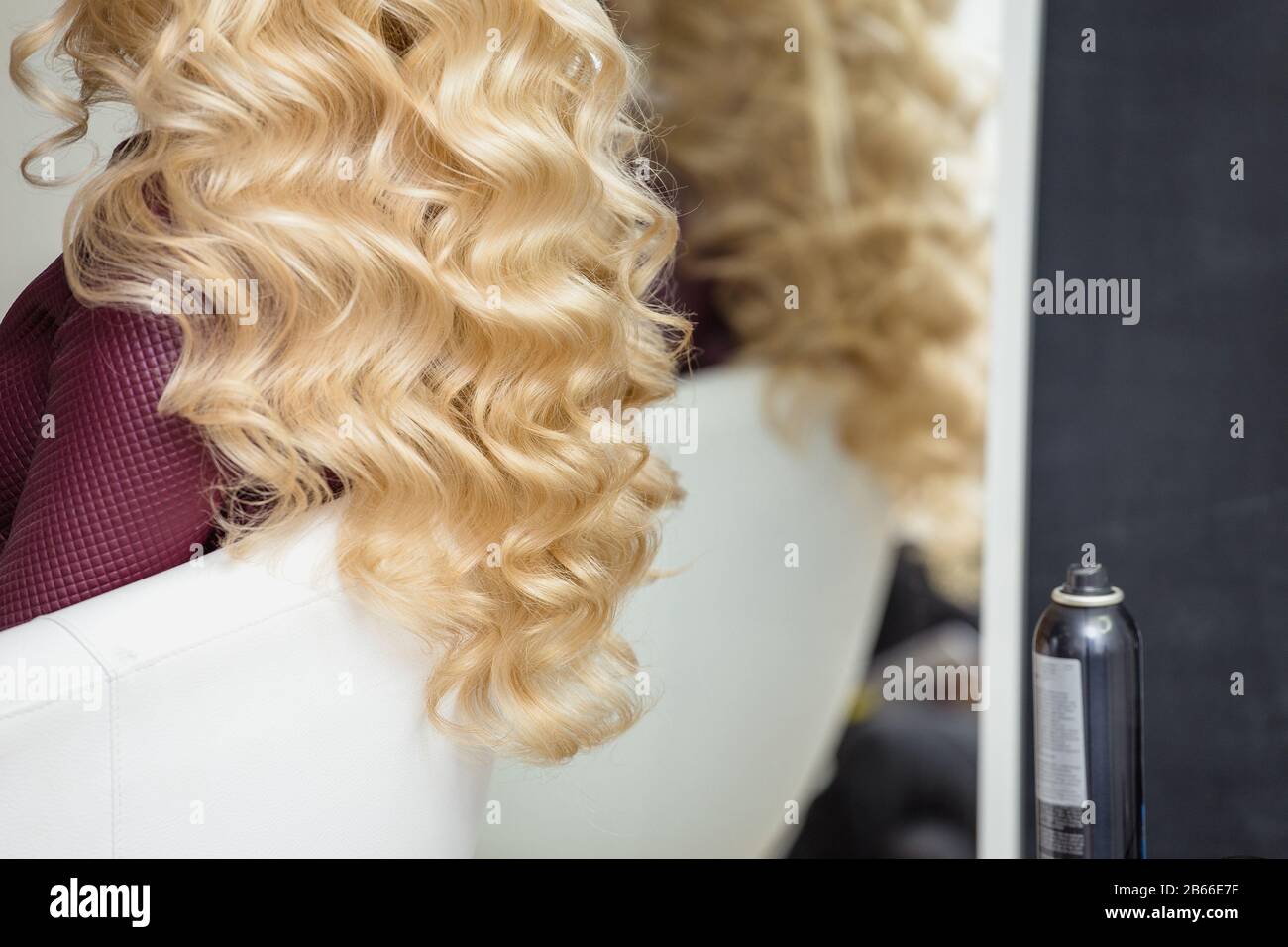 Gorgeous wavy hair flowing on woman back close-up on beauty salon ...