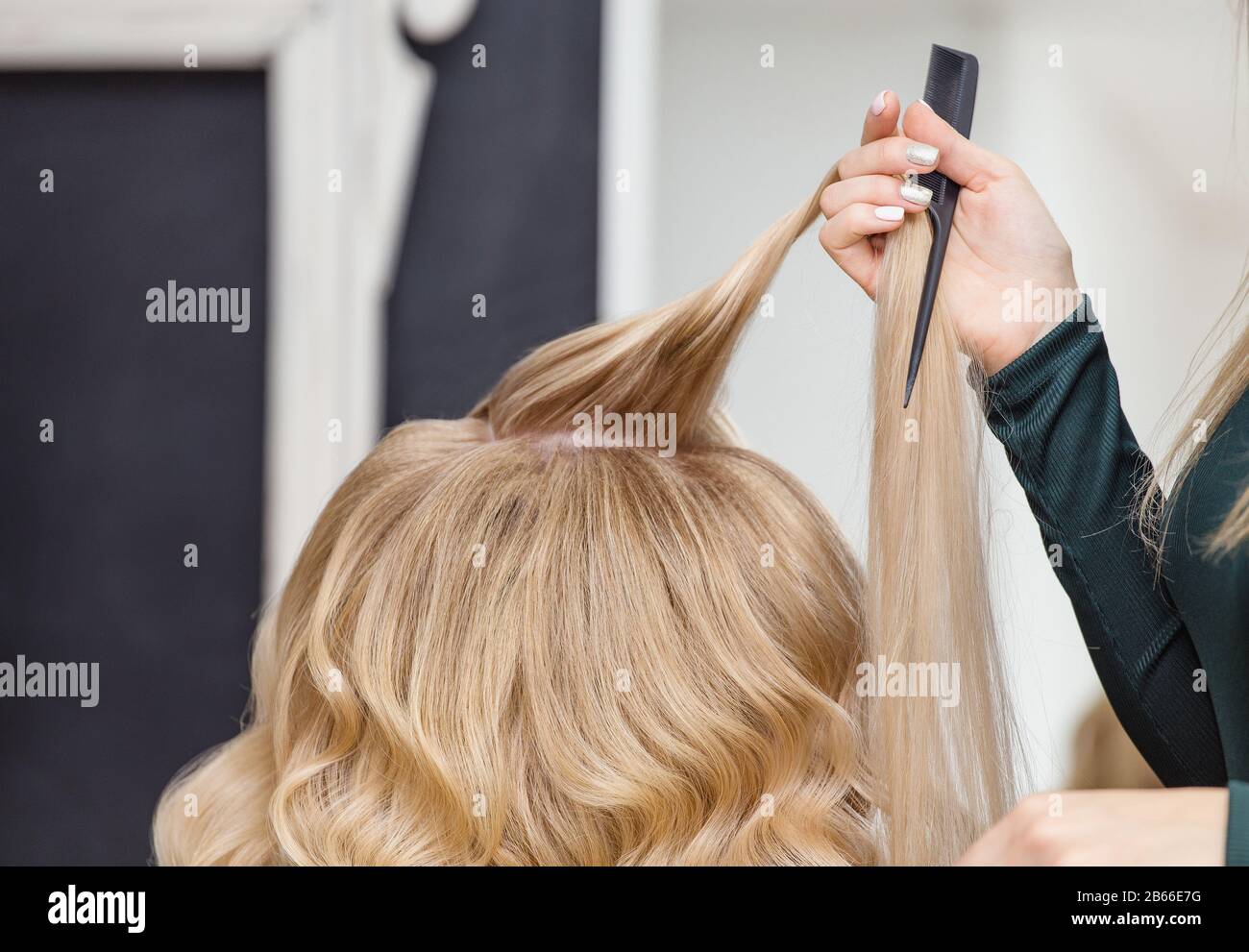 Back View Of A Beautiful Blond Woman With Long Hair and hairdresser ...