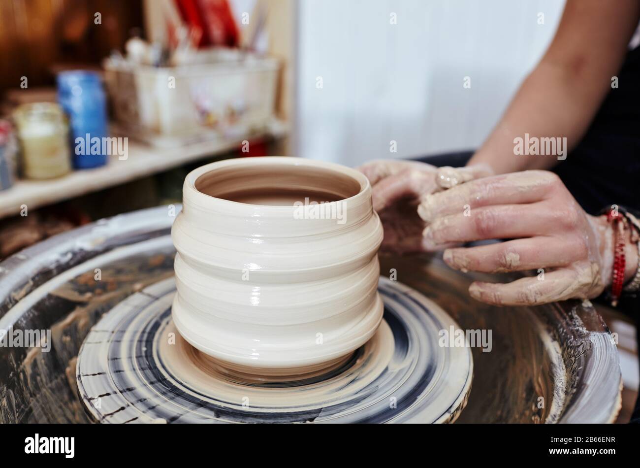 Woman's hands molding clay. Potter making ceramic pot in pottery ...