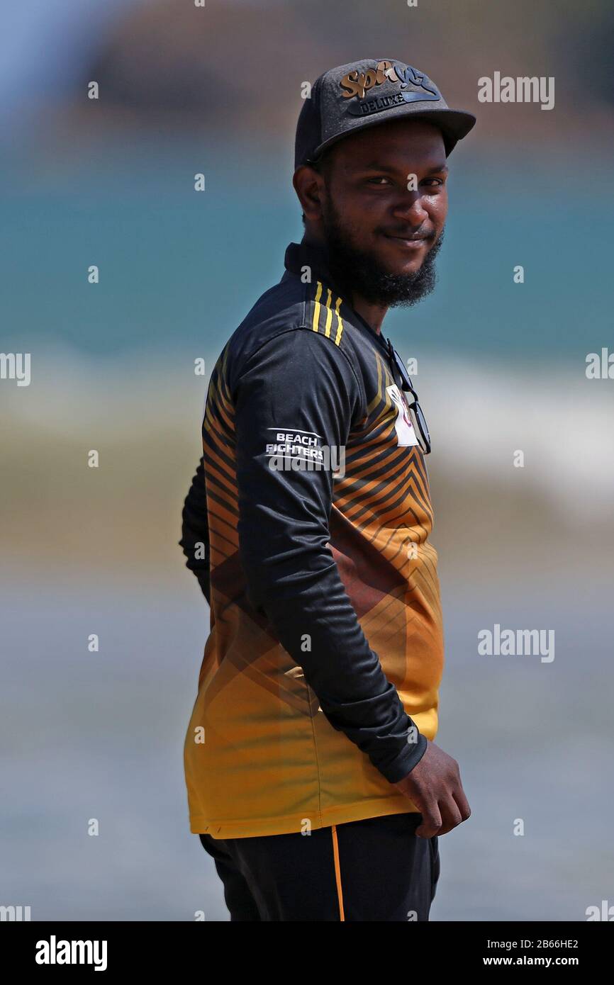 Sri Lankan cricket fans play a game of cricket on the beach at Galle ...