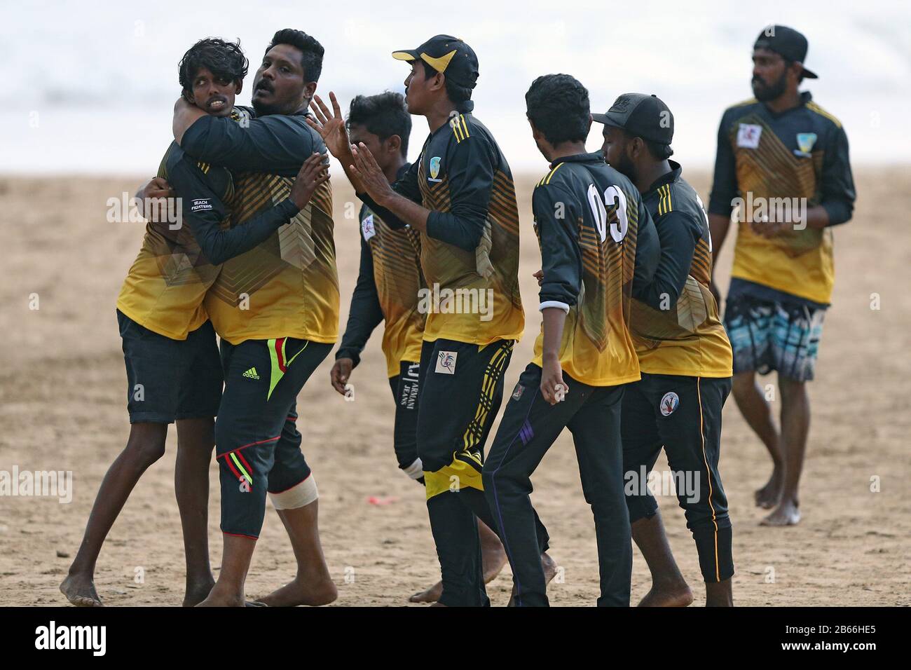 Sri Lankan cricket fans play a game of cricket on the beach at Galle ...