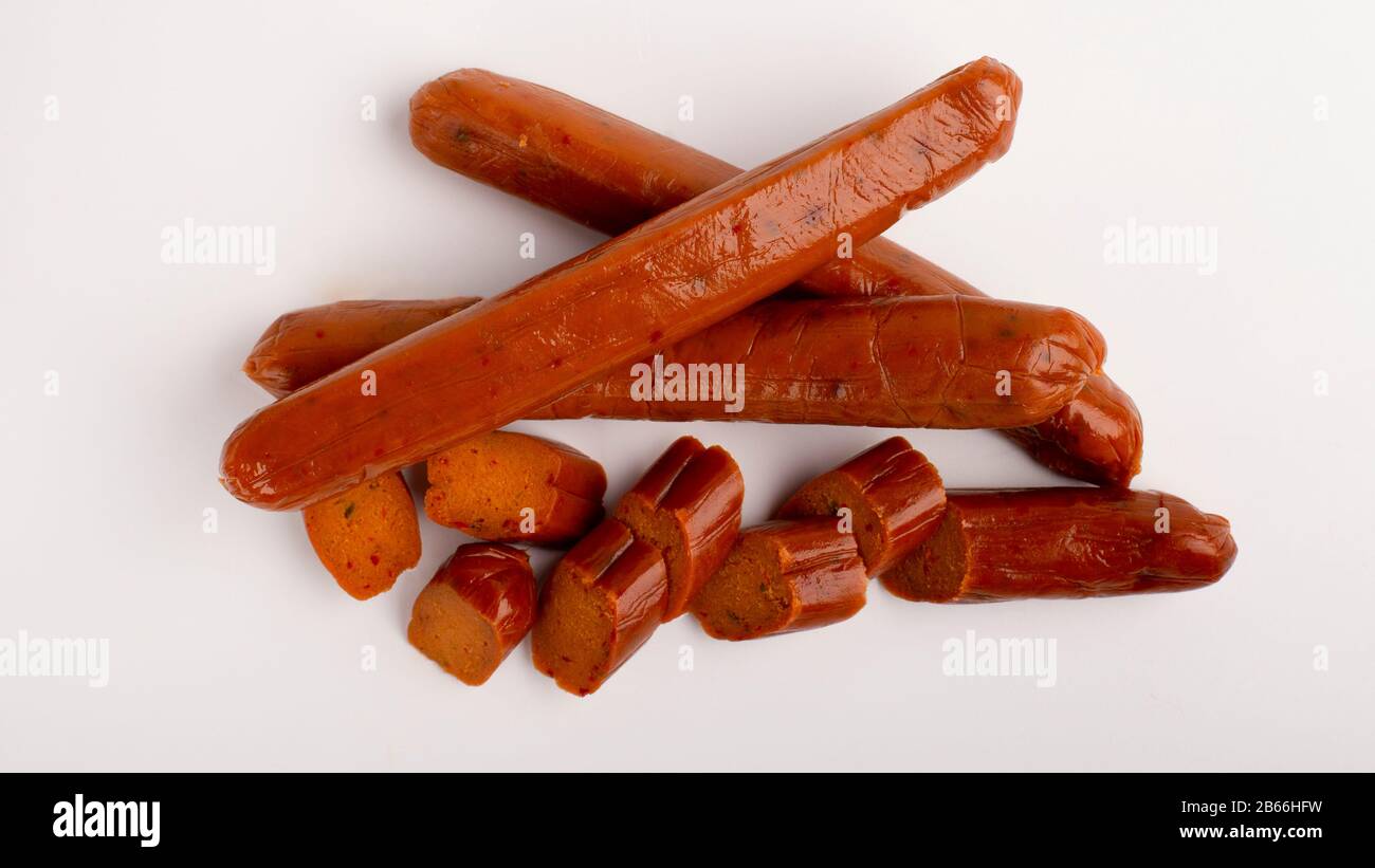 Meat substitute. Meatless sausage on white background Stock Photo - Alamy