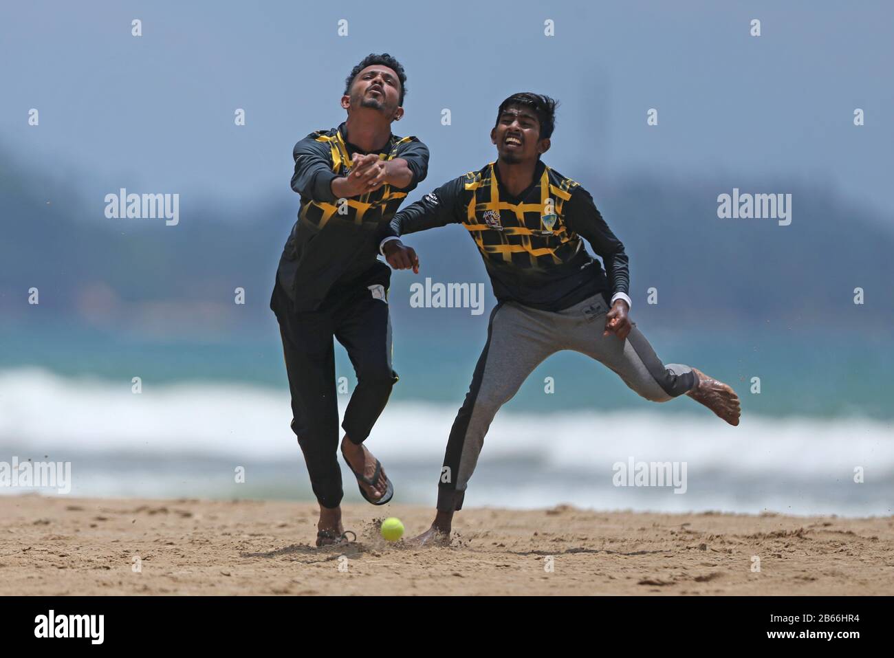 Sri Lankan cricket fans play a game of cricket on the beach at Galle ...