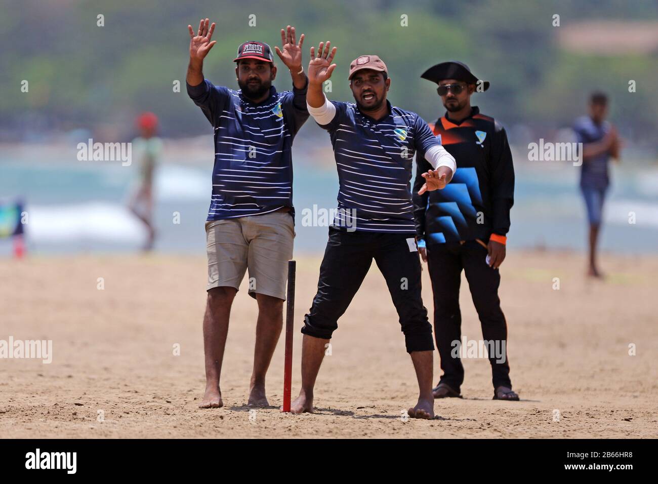 Sri Lankan cricket fans play a game of cricket on the beach at Galle ...