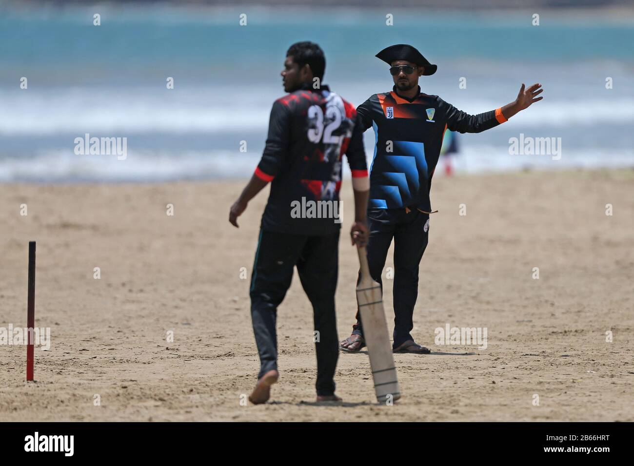 Sri Lankan cricket fans play a game of cricket on the beach at Galle ...