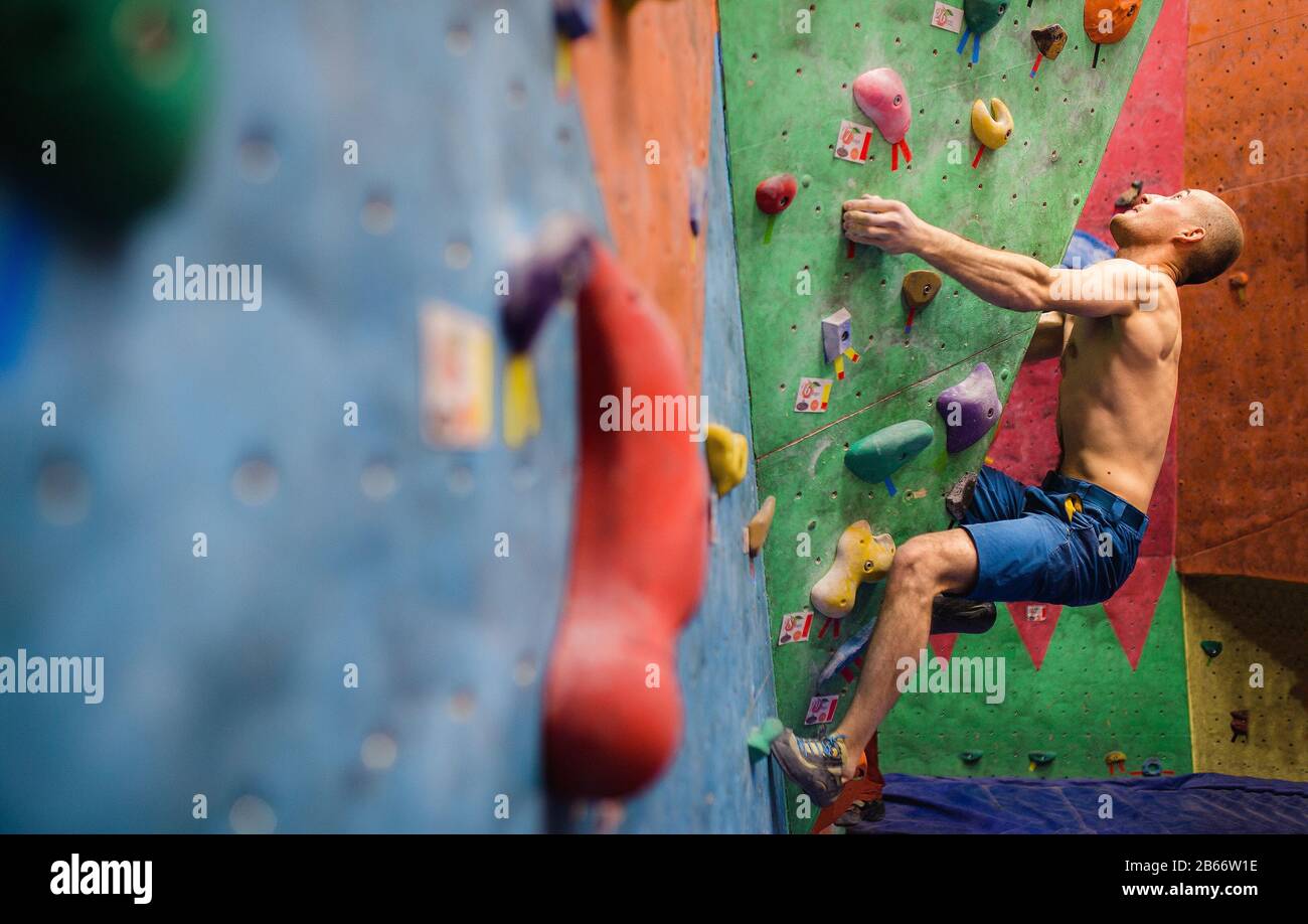 muscular and fit man exercise in free mountain climbing on indoor ...