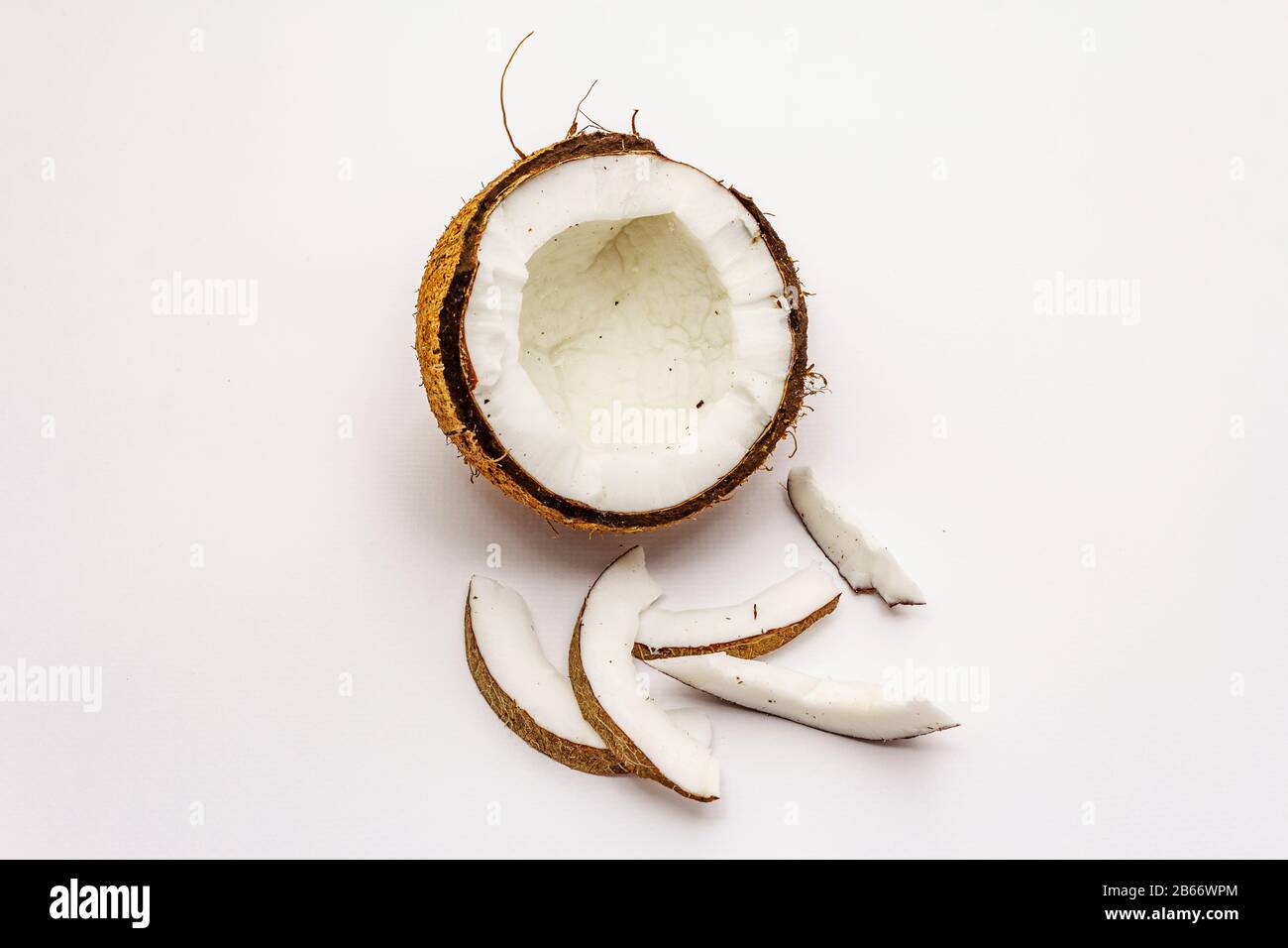 Ripe coconut cut on two half isolated on white background. Fresh fruit ...