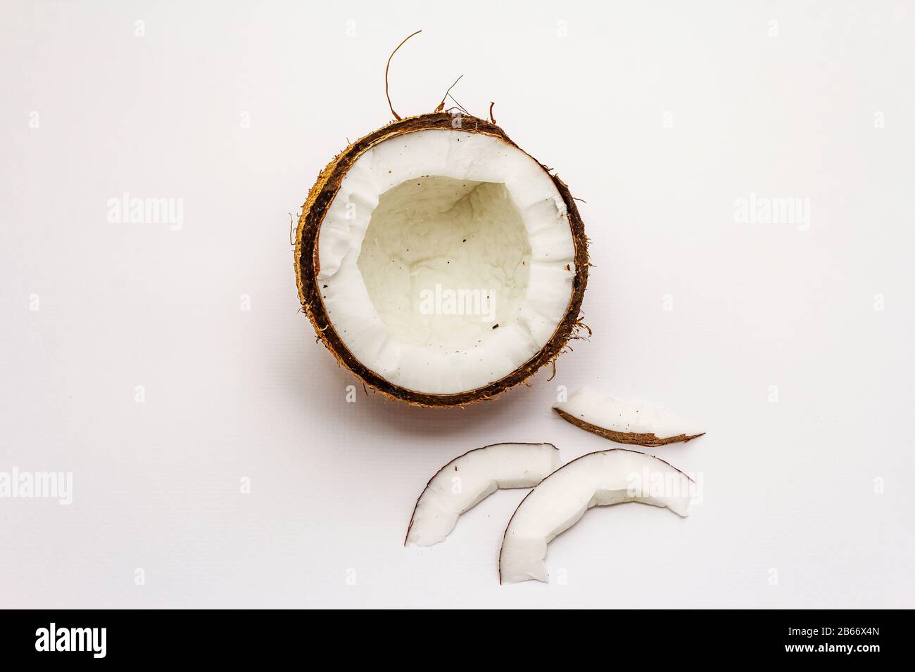 Ripe coconut cut on two half isolated on white background. Fresh fruit ...