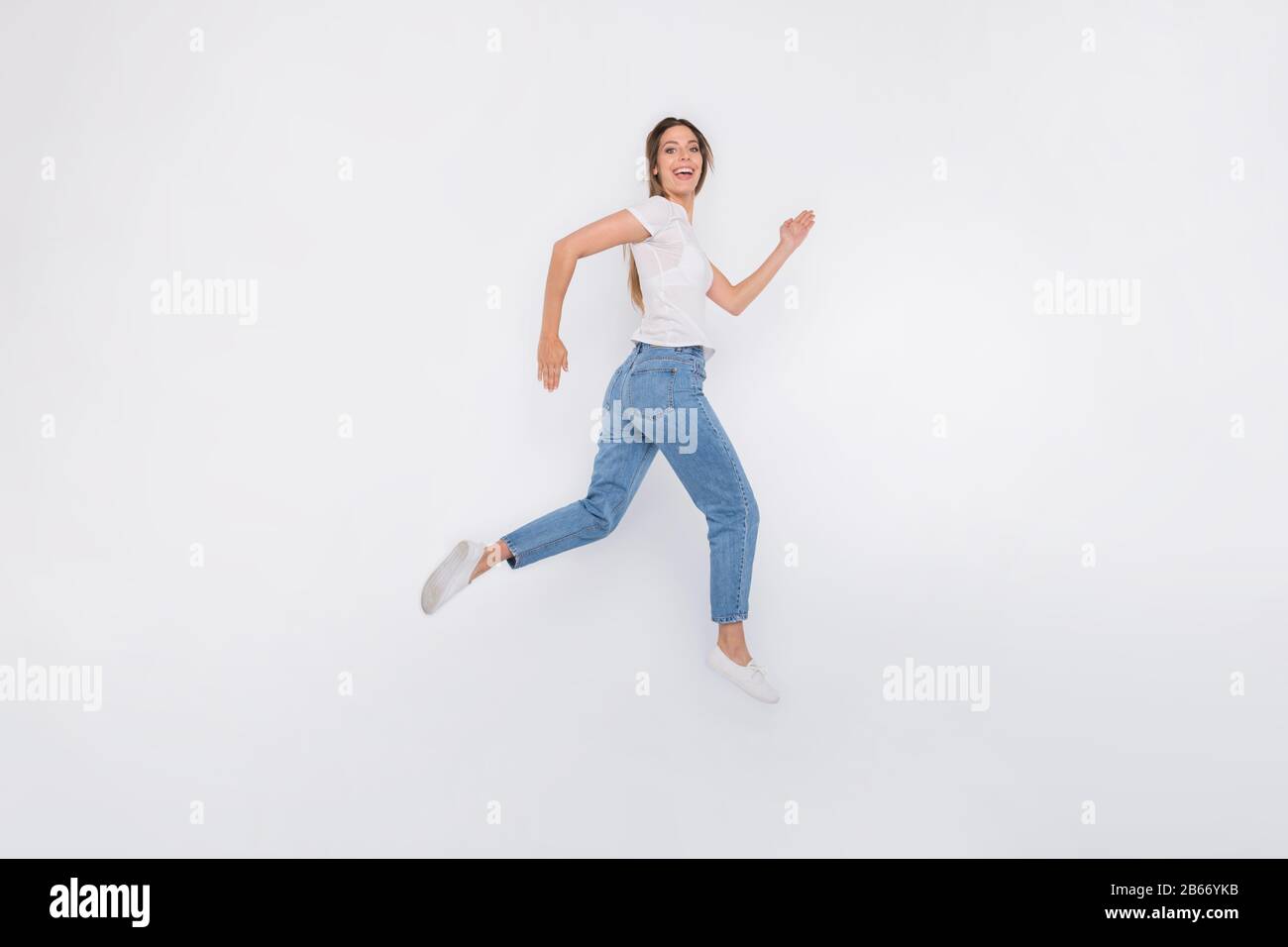 Photo of charming cute glad positive girlfriend going towards her goal ...
