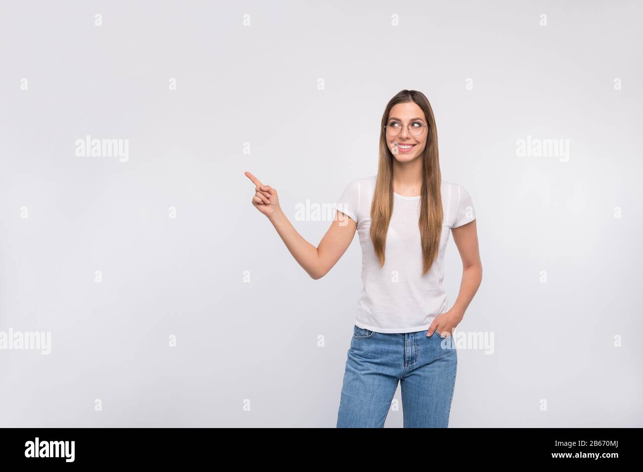 Photo of pretty lady indicating finger empty space on low prices banner ...