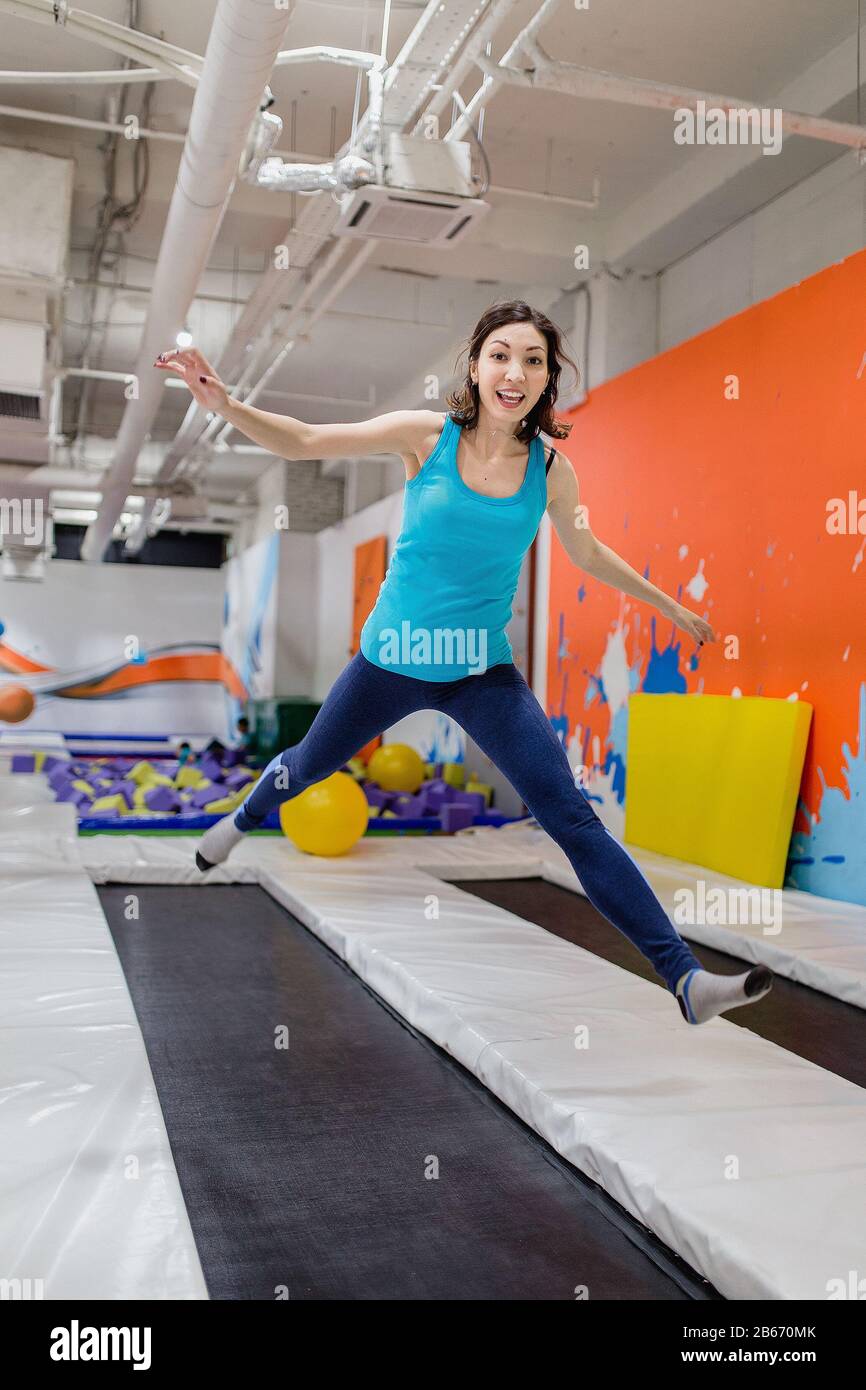 Fitness woman have fun and jumping on professional trampoline Stock ...