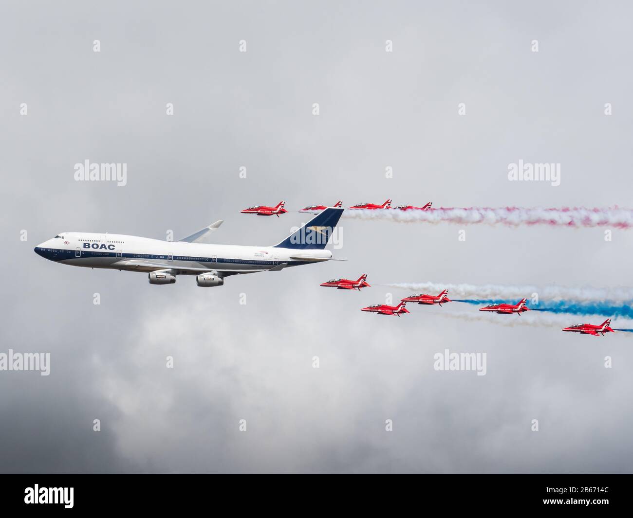 A BOAC British Airways Boeing 747-436 and Red Arrows fly past at the ...