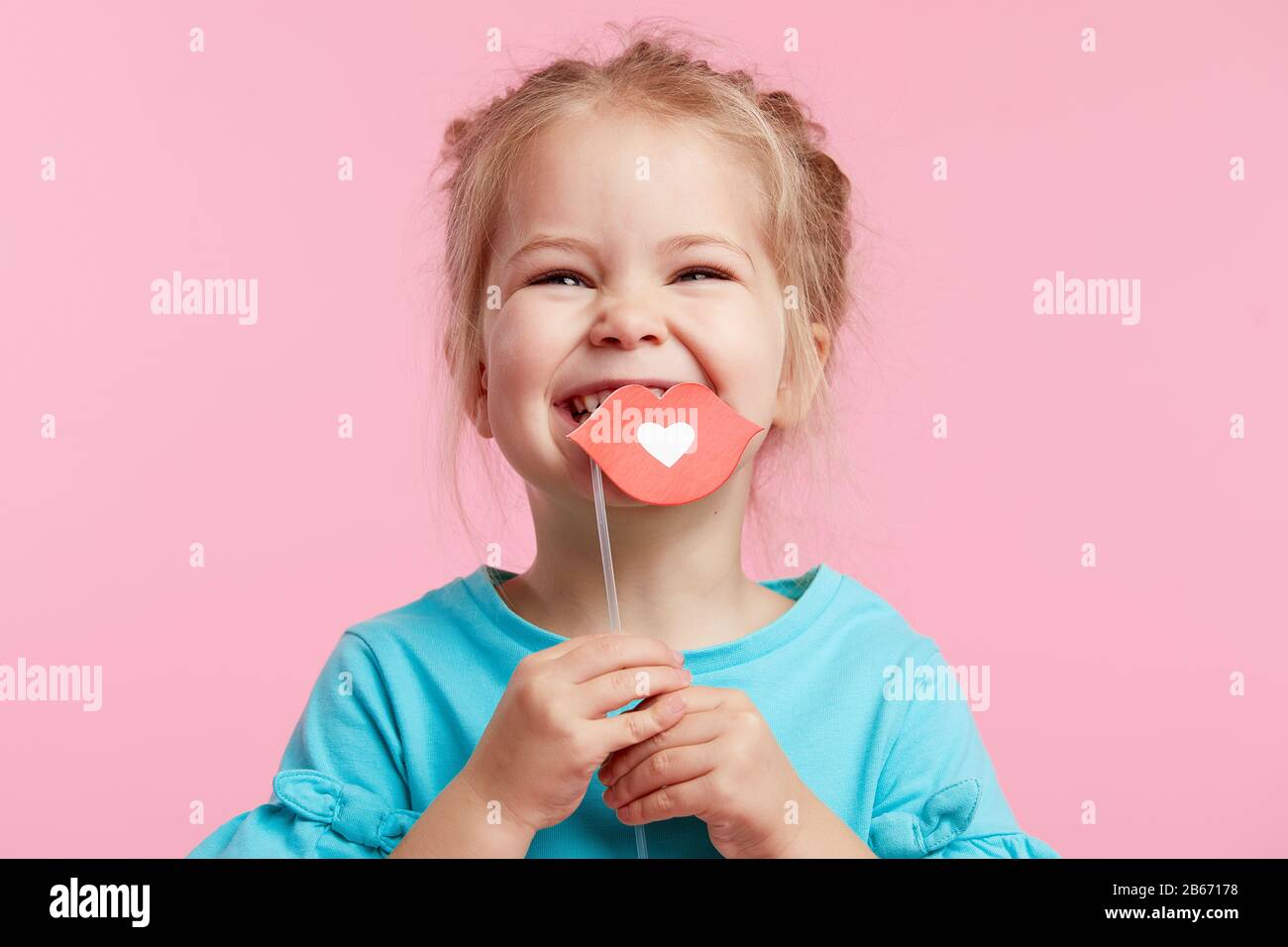 Funny smilly girl on the background of a bright pink wall. Child girl ...