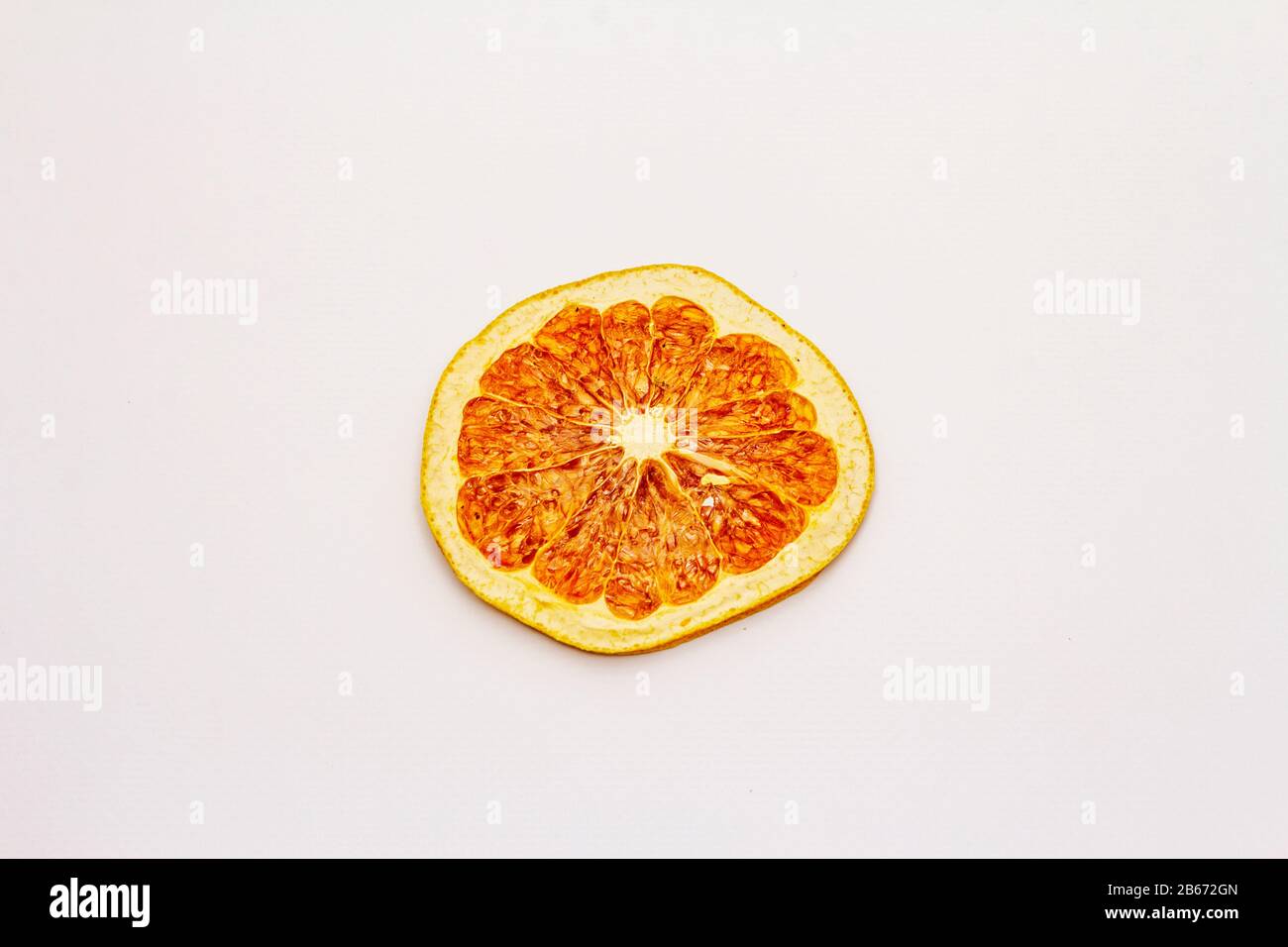 Dried single slice of grapefruit isolated on white background. Healthy ...
