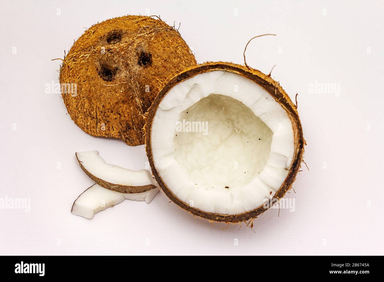 Ripe coconut cut on two half isolated on white background. Fresh fruit ...