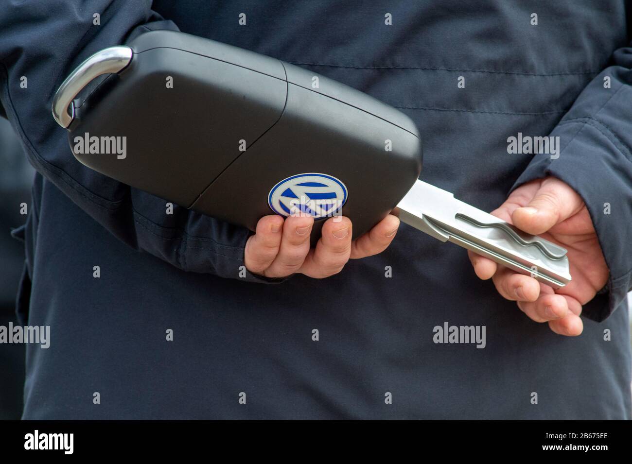 09 March 2020, Saxony-Anhalt, Magdeburg: A man is holding an oversized ...