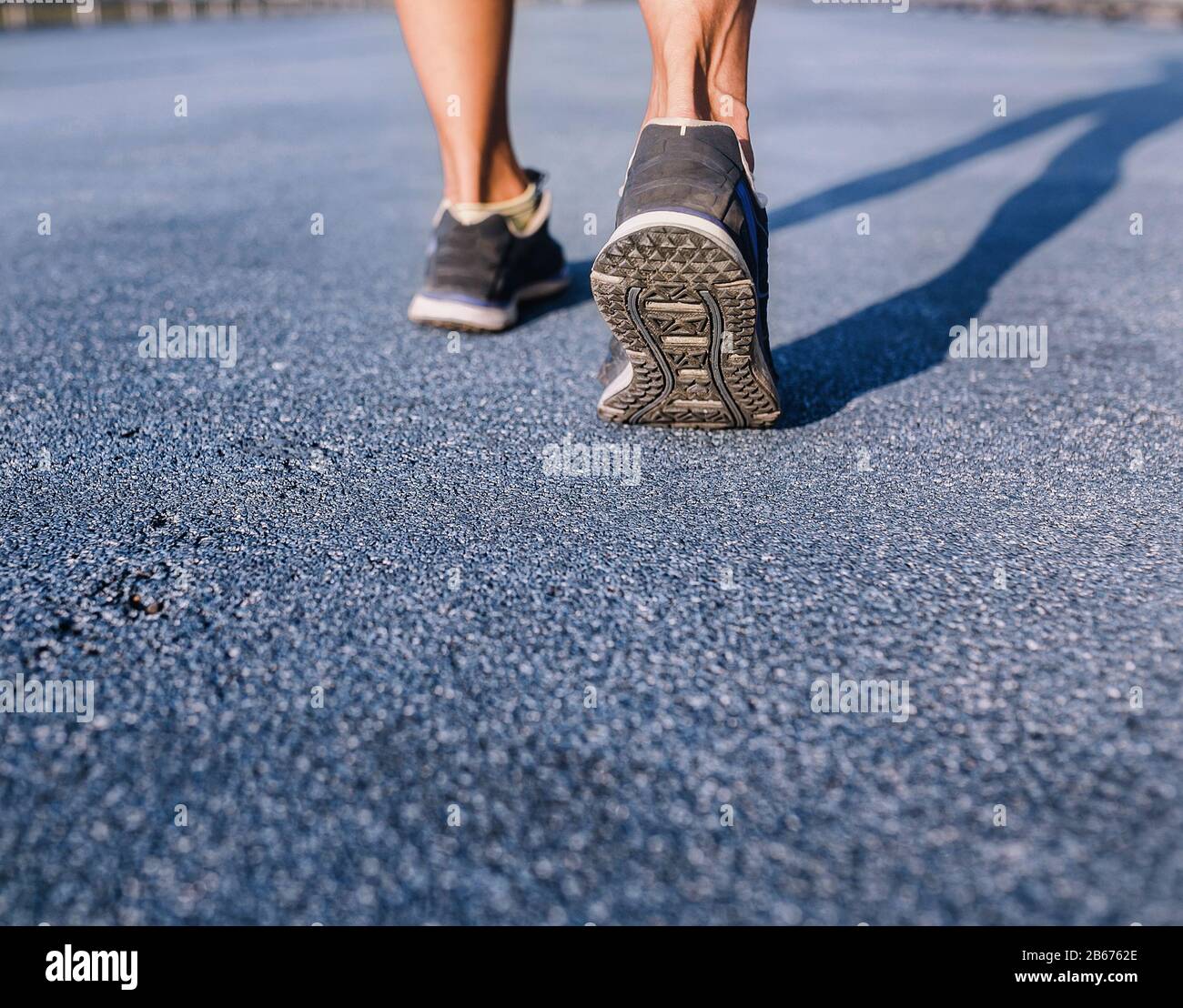 Woman muscle runner feet on road closeup on shoe Stock Photo - Alamy