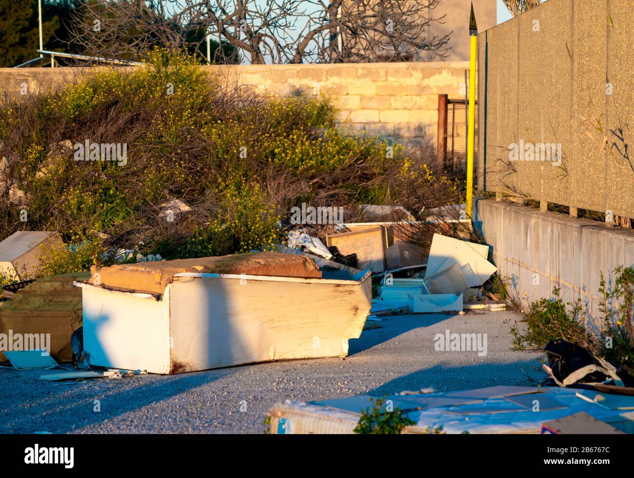 A rural wasteland in countryside scene with dirty ground alley, meadow ...