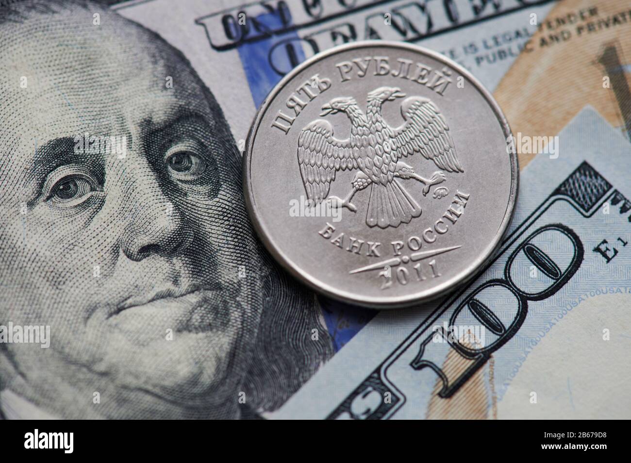 Metal ruble coin on dollar banknote close up view Stock Photo - Alamy