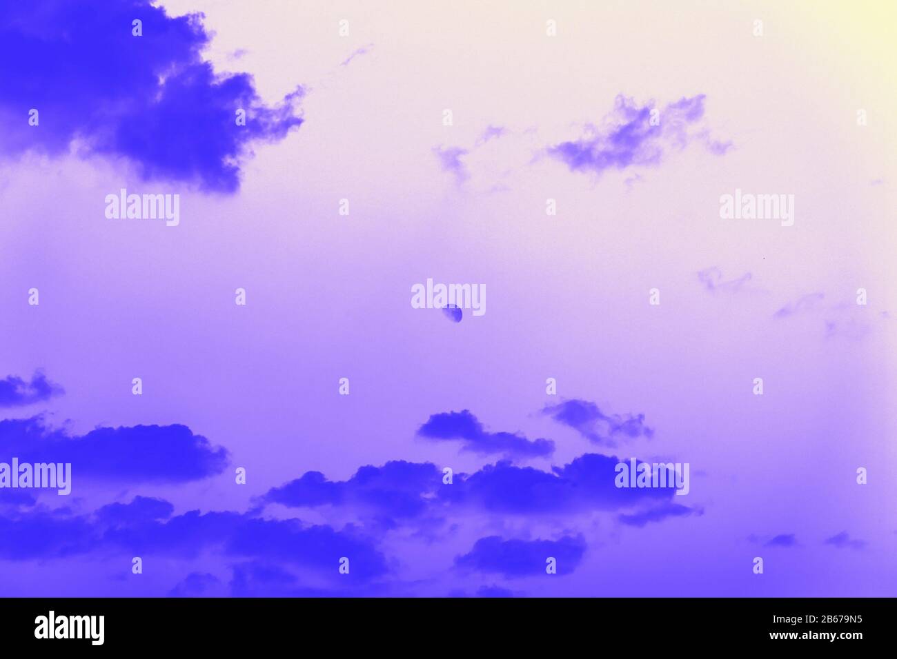 Moon behind the clouds, violet blue toned Stock Photo - Alamy