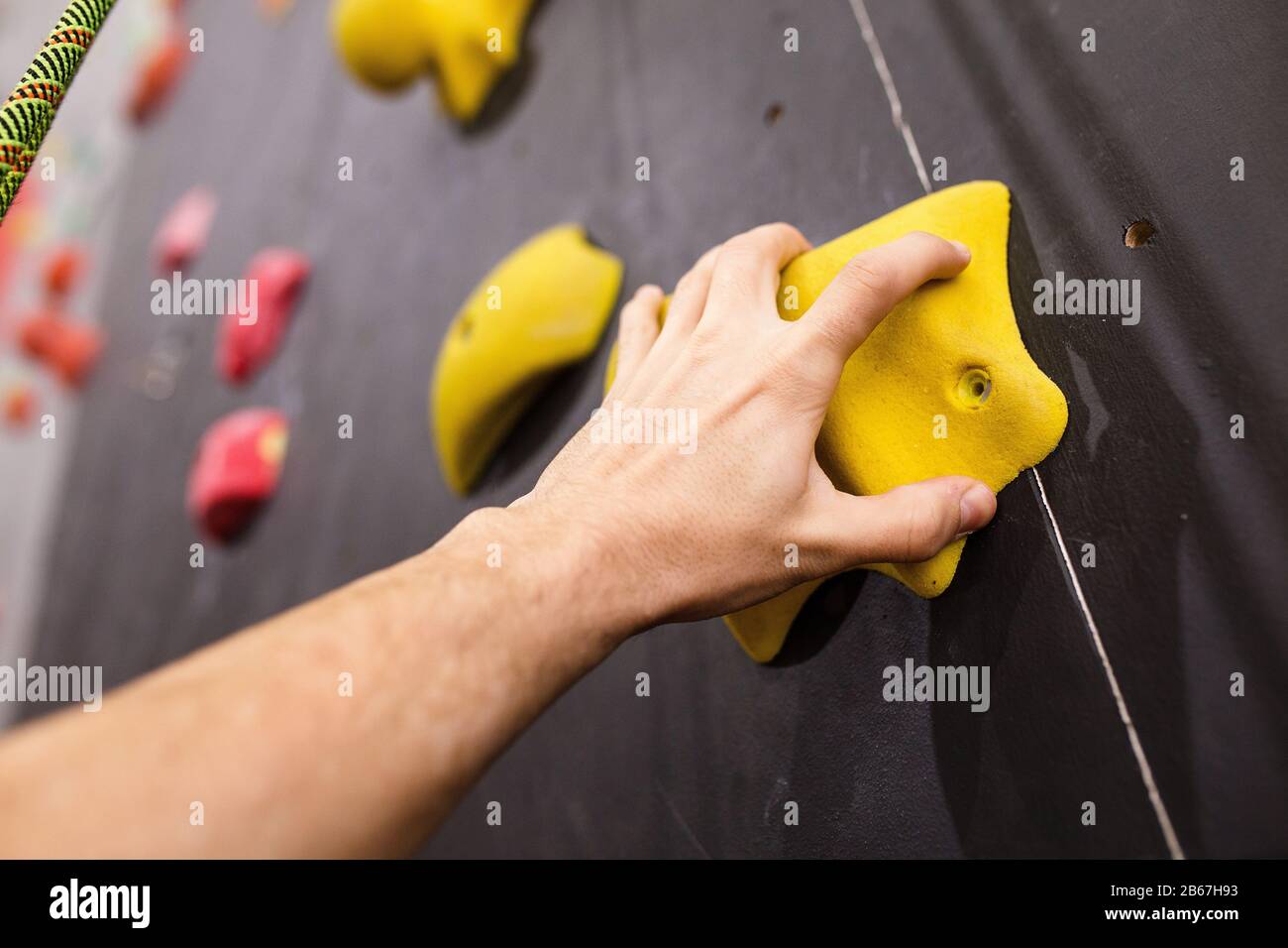 Hand climber clinging tightly to the hook at indoors climbing gym Stock ...