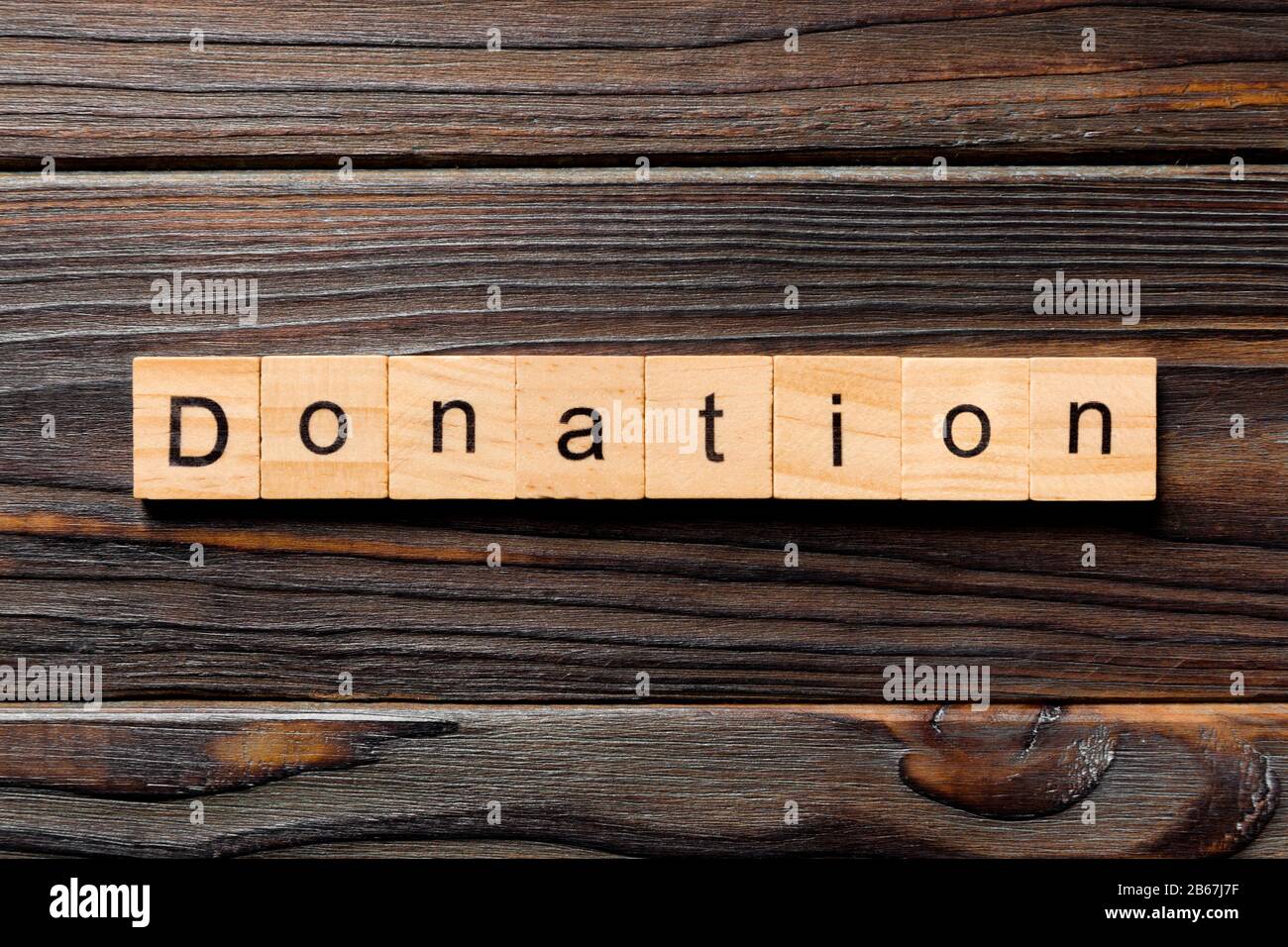 donation word written on wood block. donation text on table, concept ...