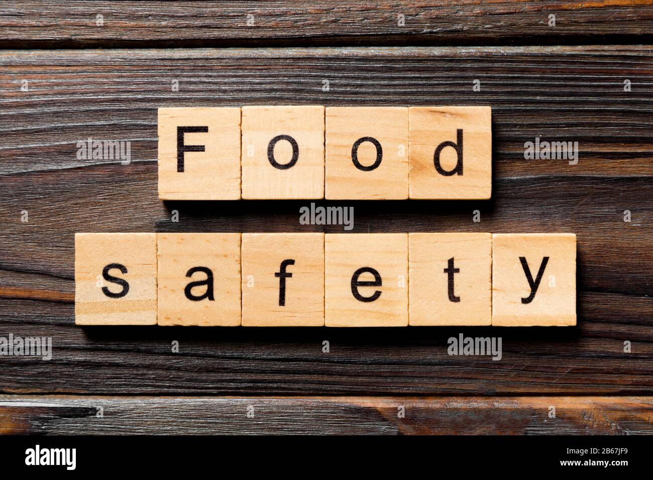 food safety word written on wood block. food safety text on table ...