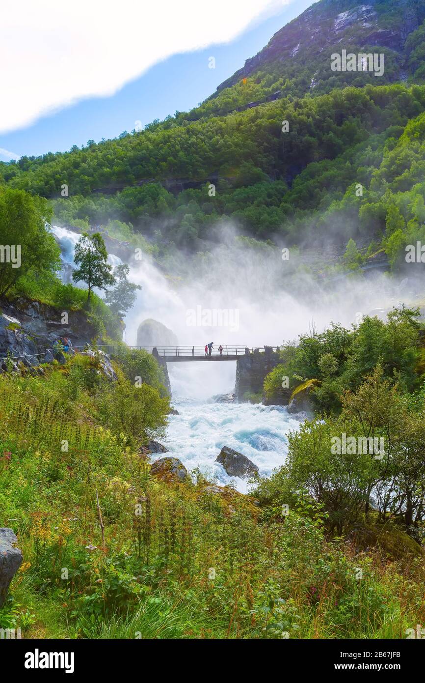 Waterfall and bridge to Briksdal or Briksdalsbreen glacier in Olden ...