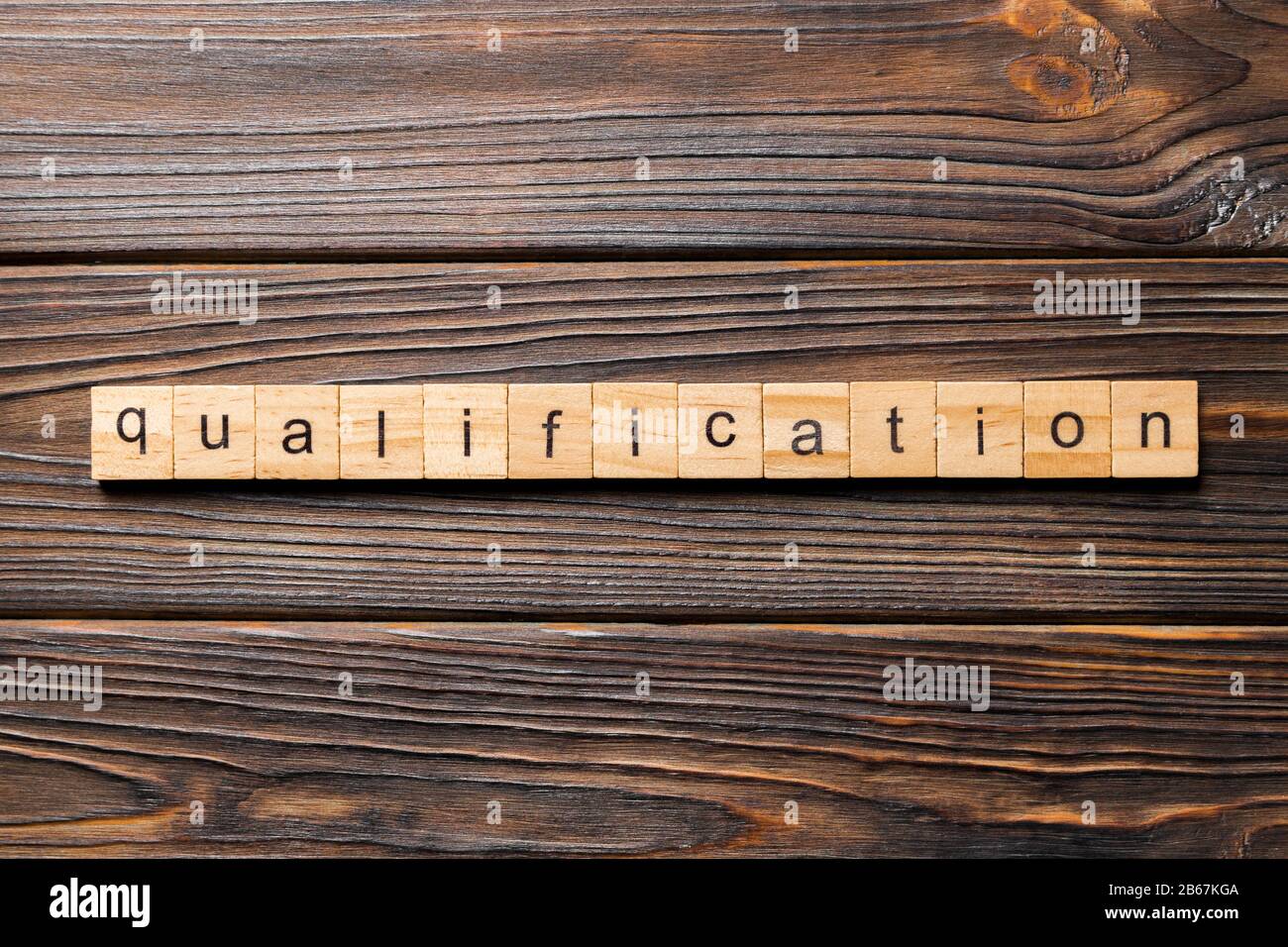 qualification word written on wood block. qualification text on table ...