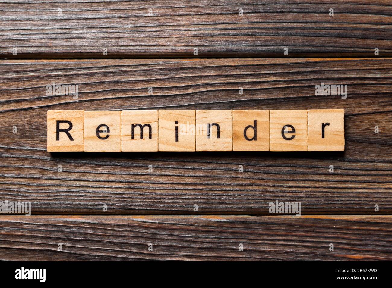REMINDER word written on wood block. REMINDER text on wooden table for ...