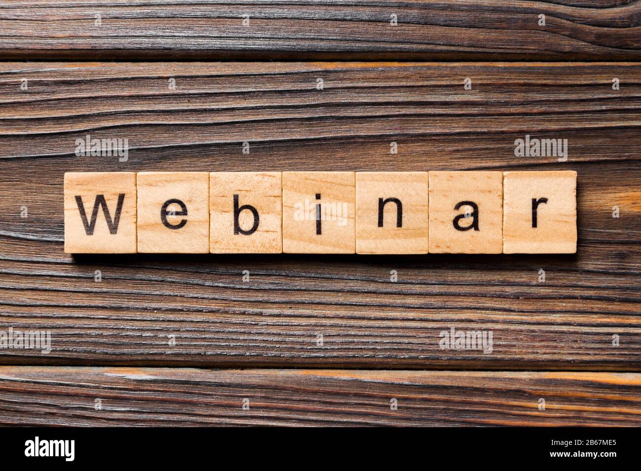 WEBINAR word written on wood block. WEBINAR text on wooden table for ...