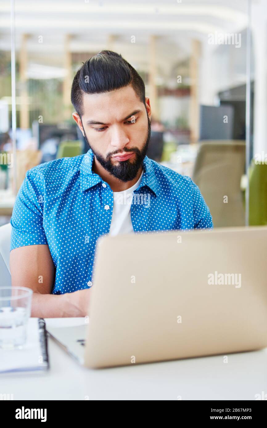 Concentrated IT programmer works on the computer in the office Stock ...