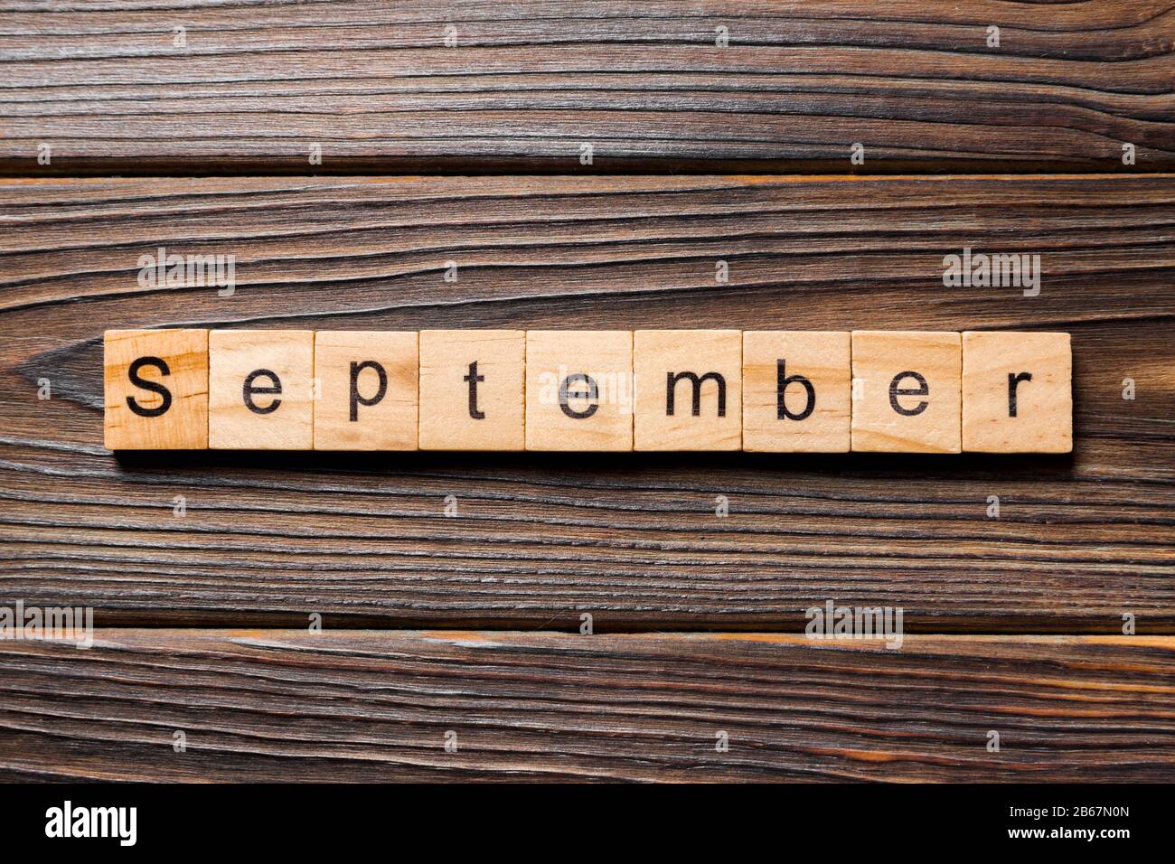 September word written on wood block. September text on wooden table ...