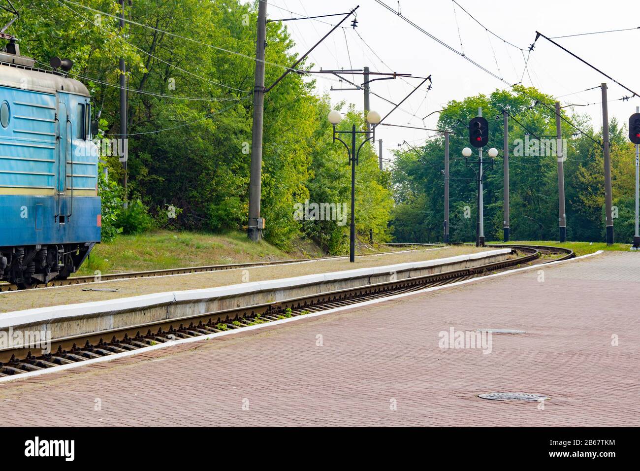 Old blue passenger train at the railway station Stock Photo - Alamy
