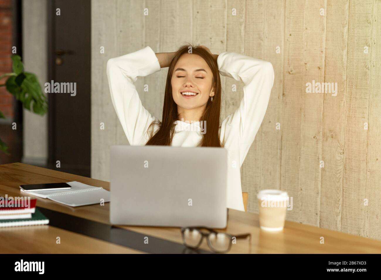 Break during work. Freelance girl closed eyes Stock Photo - Alamy